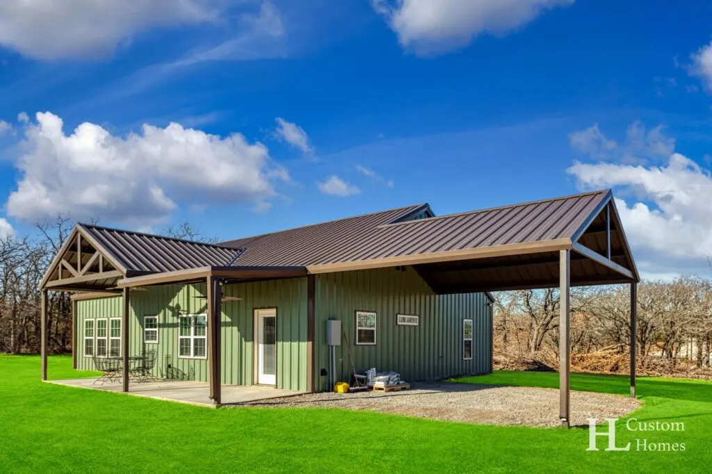 Green Barndominium with Carport by HL Custom Homes (Rolling Hills, TX)