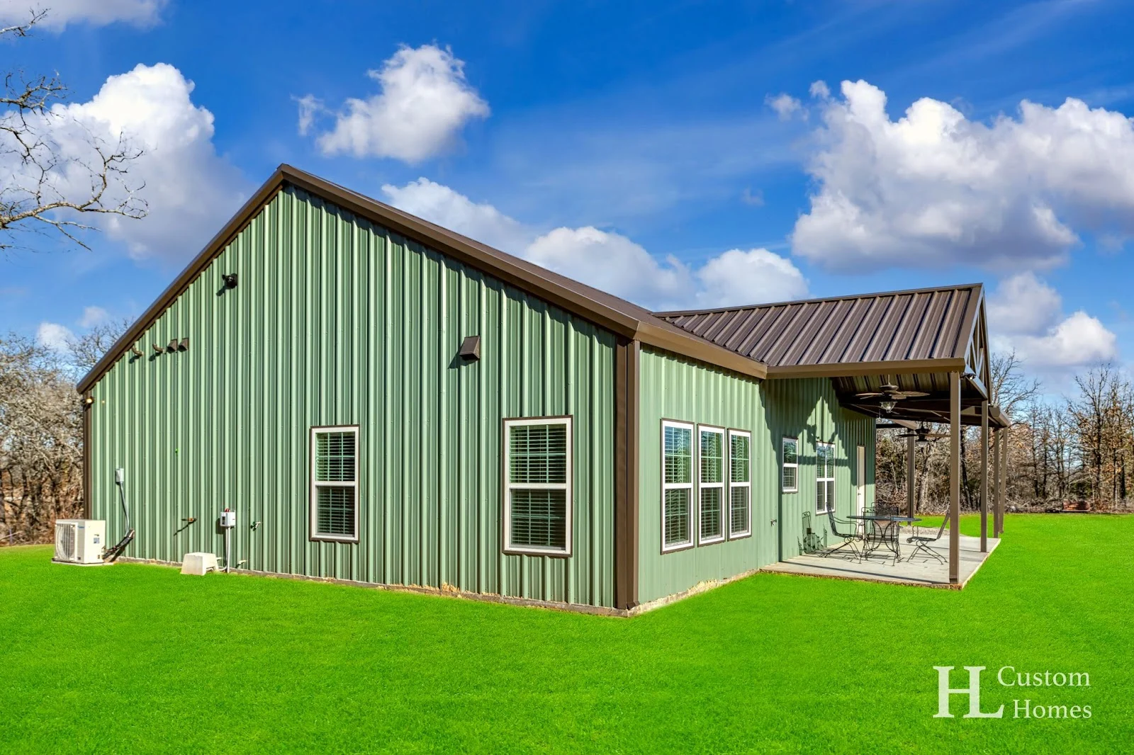 Green Barndominium with Carport by HL Custom Homes (Rolling Hills, TX)
